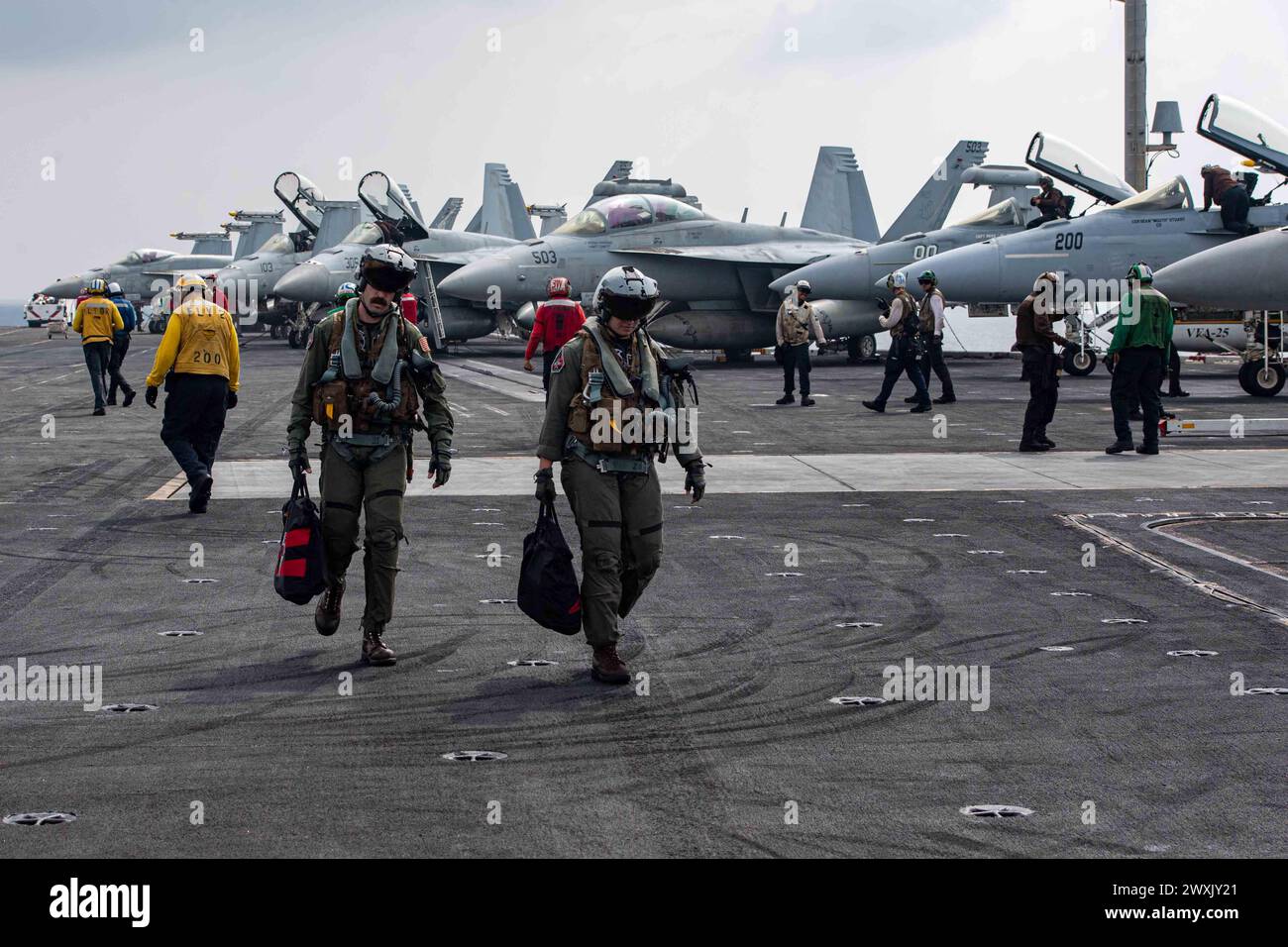 SOUTH CHINA SEA (March 28, 2024) U.S. Navy Lt. Clay Elward (left), and ...