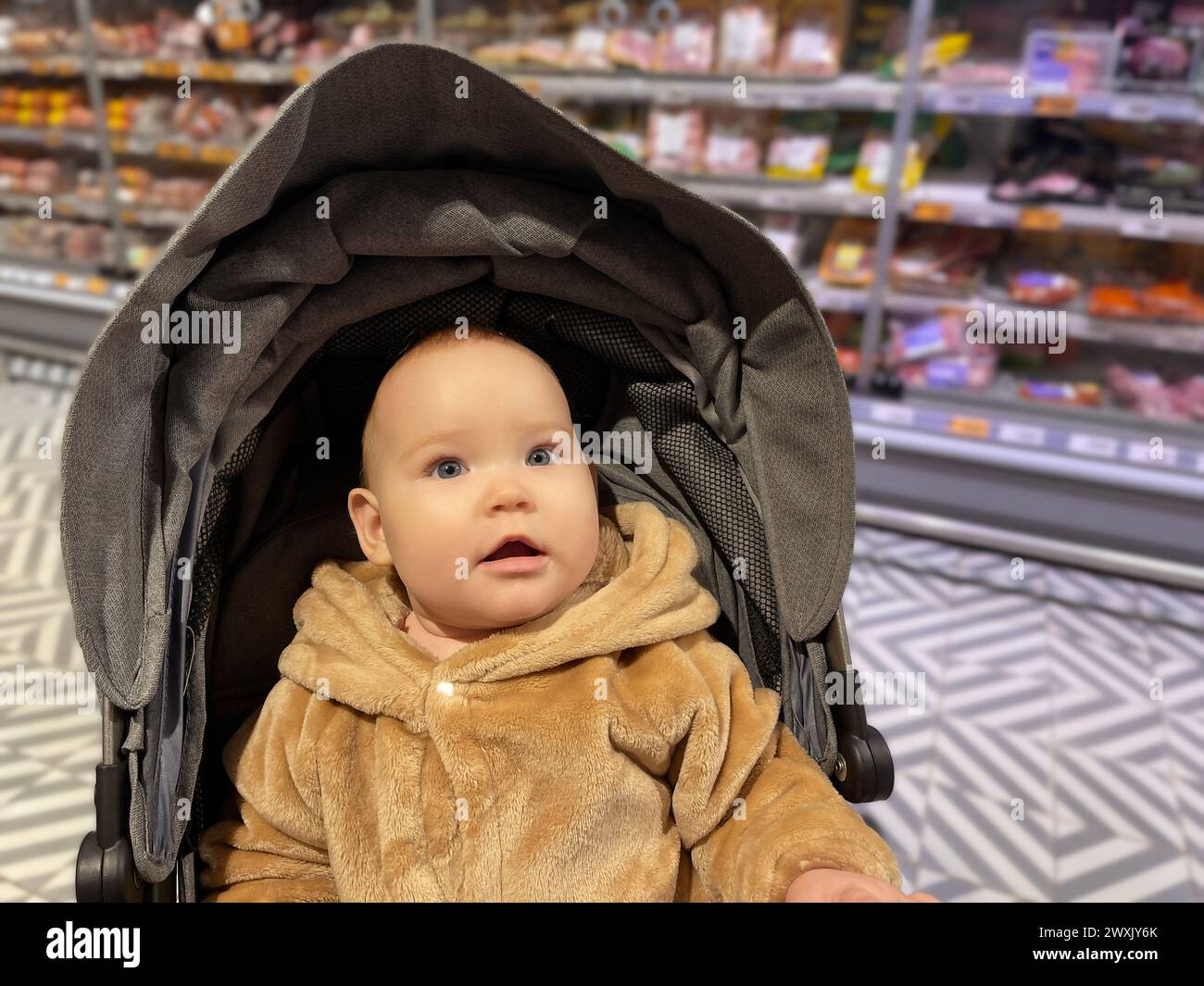 Curious Baby in a Stroller in Supermarket Stock Photo - Alamy