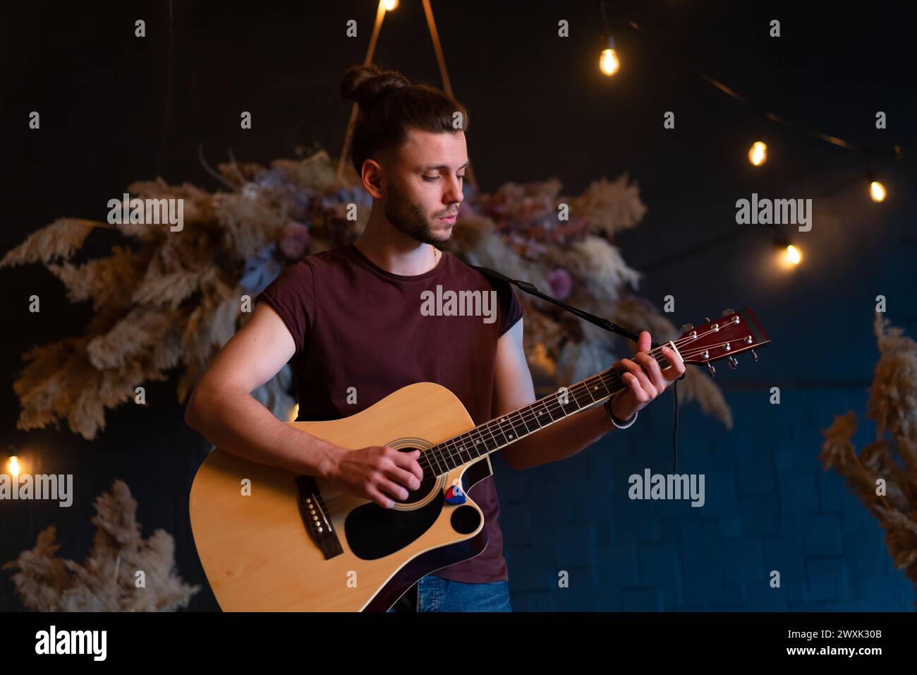 Male musician playing acoustic guitar. Guitarist plays classical guitar ...