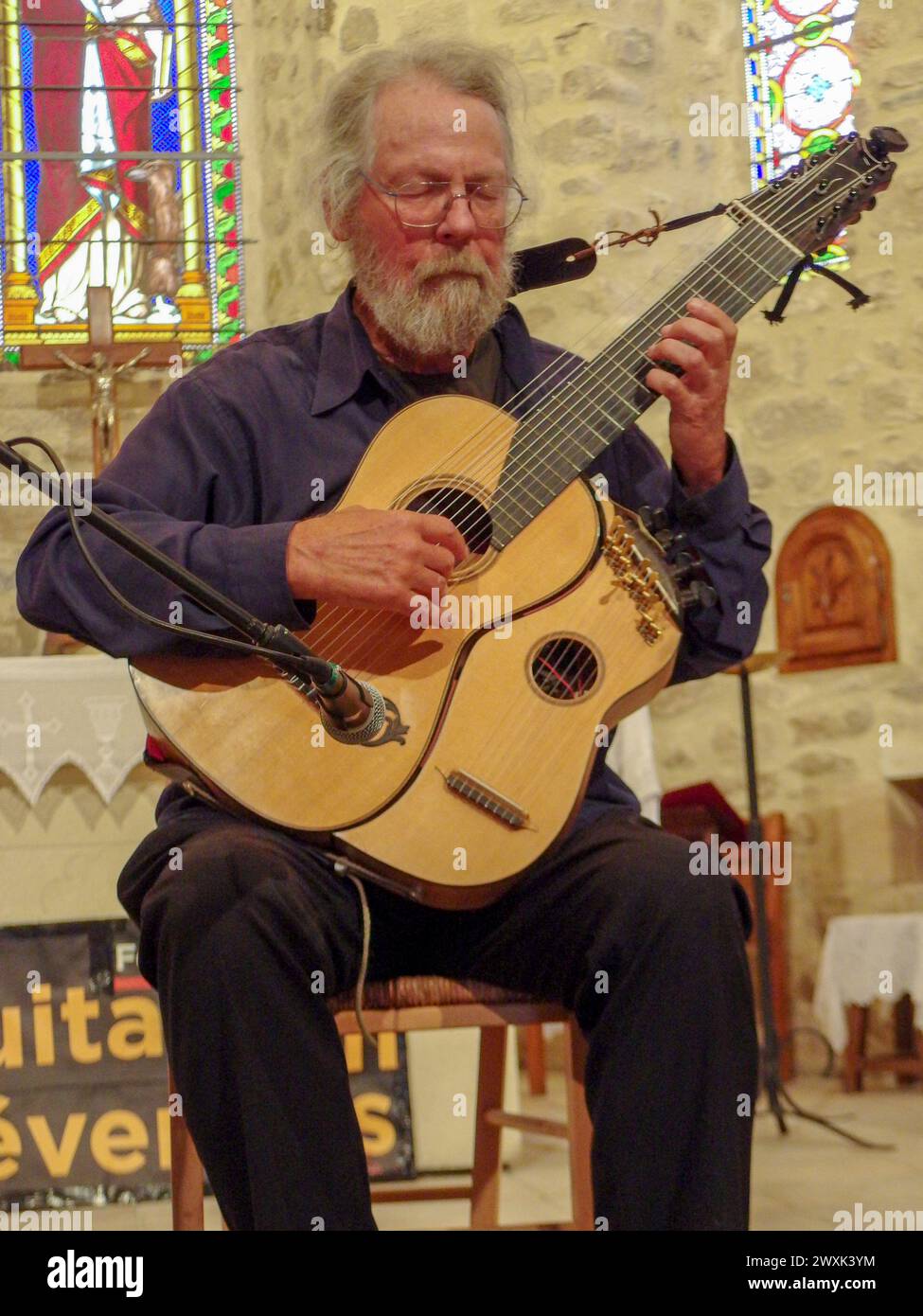 Scottish musician James Kline with his 19-string arch harp guitar, a ...