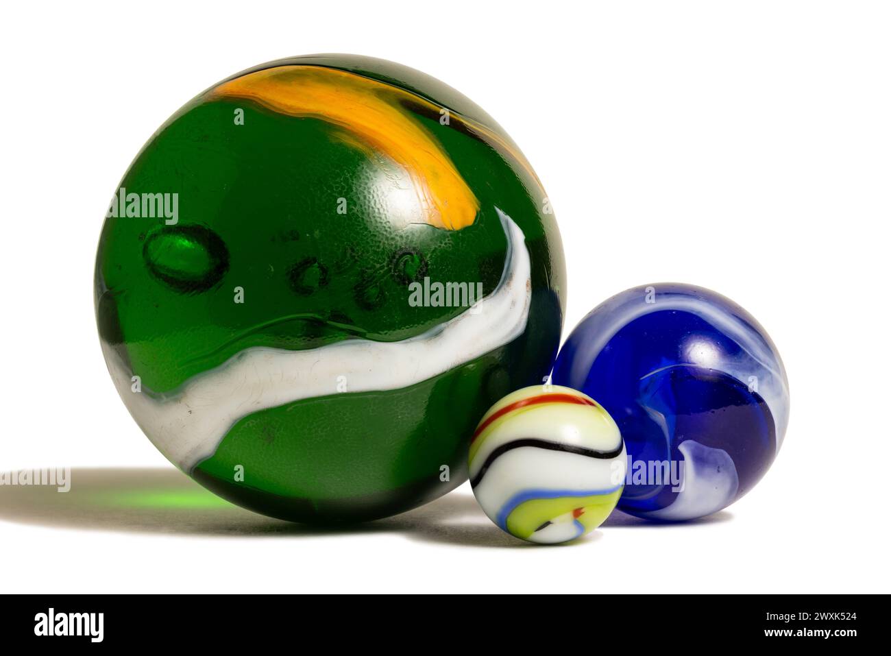 Three glass marbles in three different sizes Stock Photo - Alamy
