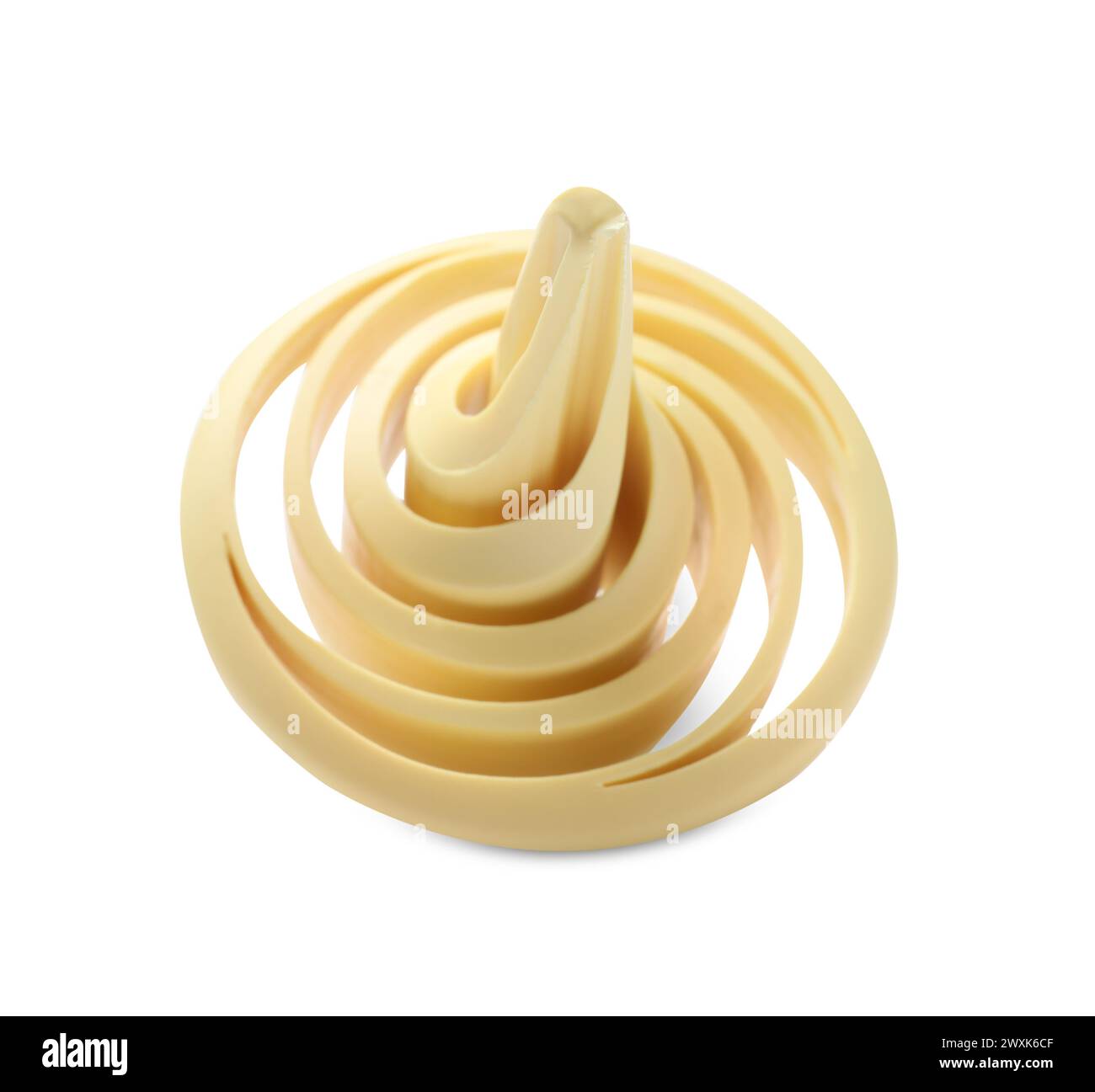 One pale yellow spinning top on white background Stock Photo - Alamy