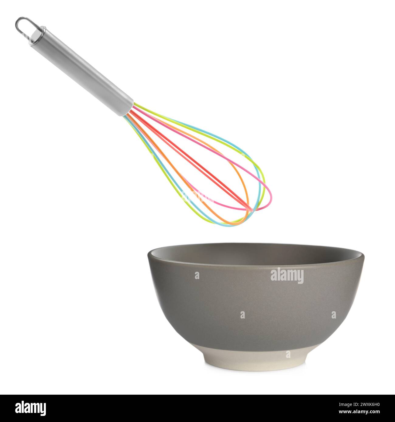 Colorful whisk and ceramic bowl isolated on white. Cooking utensils ...