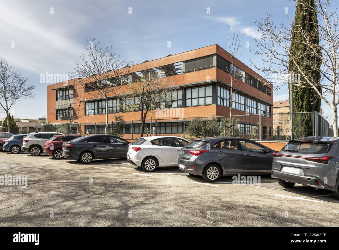 Terracotta brick and black metal facade of office building with ...