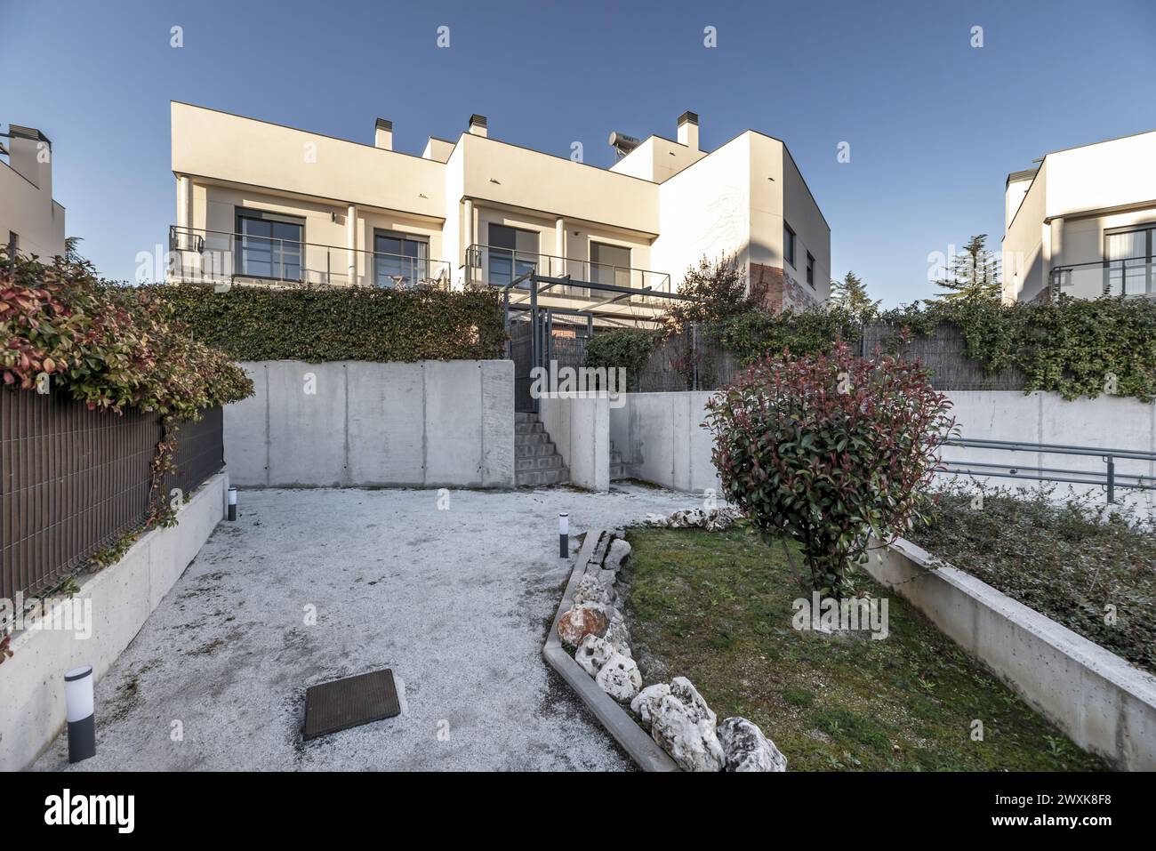 Facades of modern minimalist style terraced houses with concrete walls ...