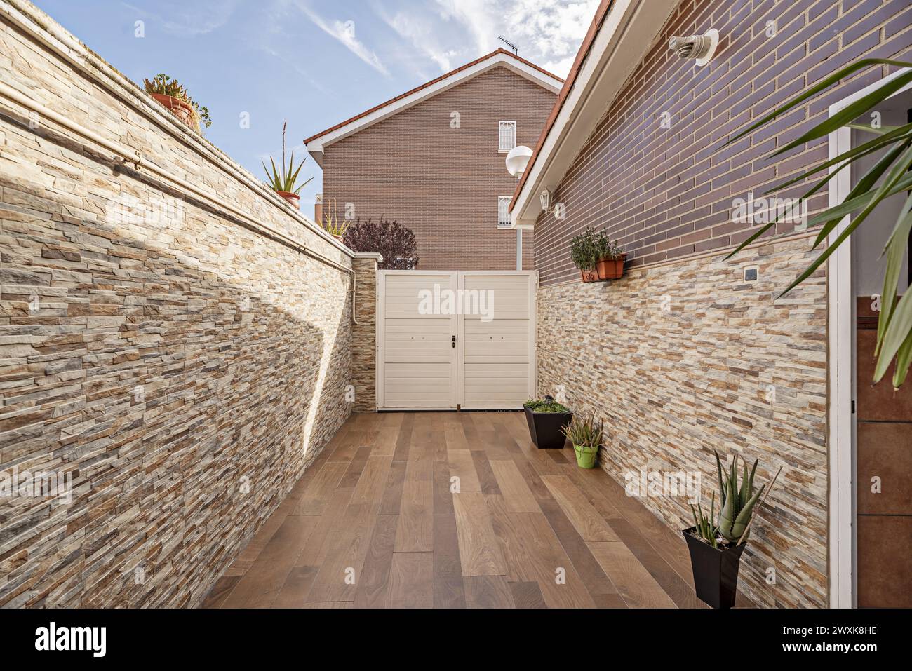 Uncovered entrance of a multi-story detached house with brick facades ...
