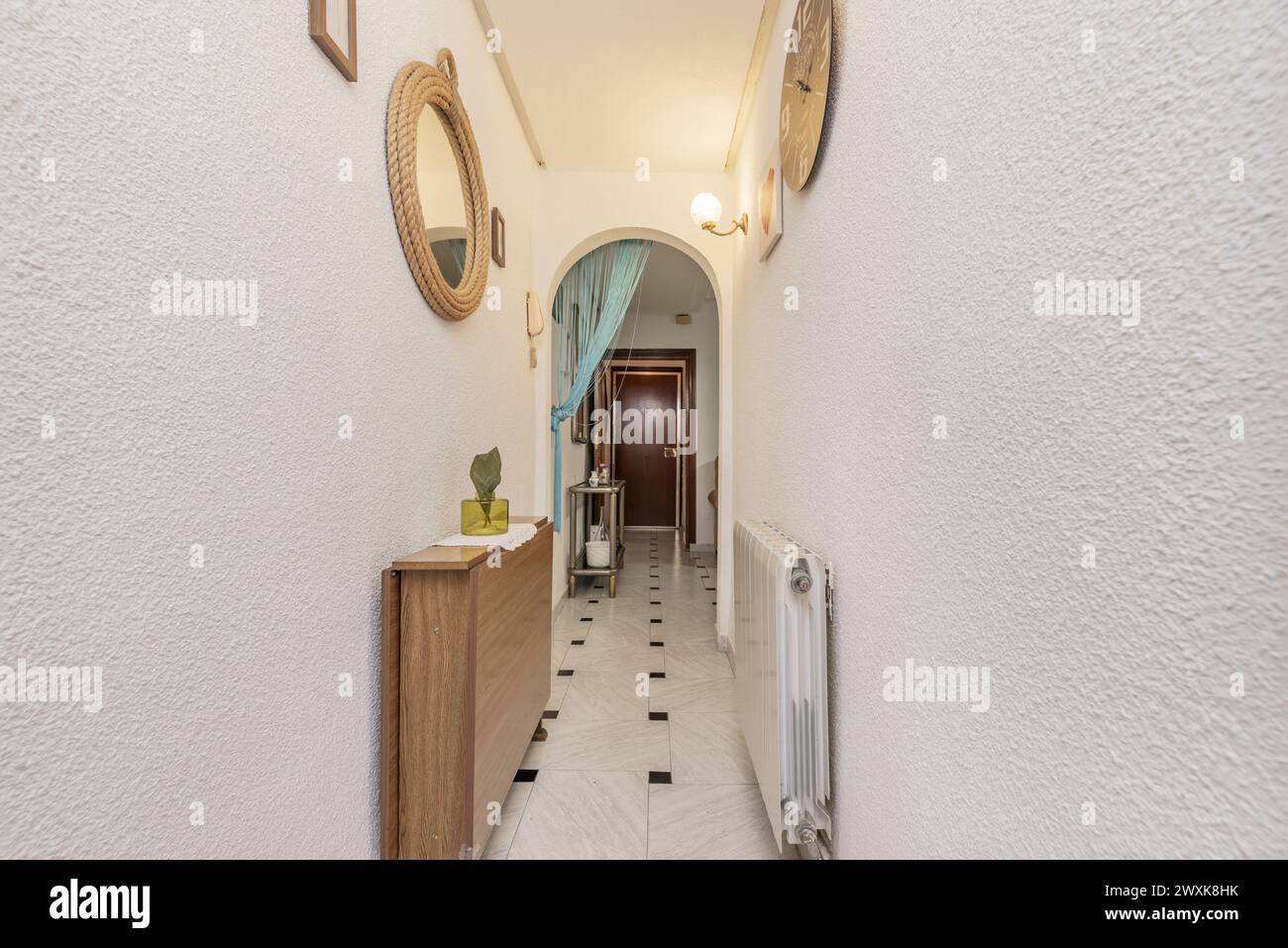 Hallway of an apartment with black and white stoneware floors, white ...