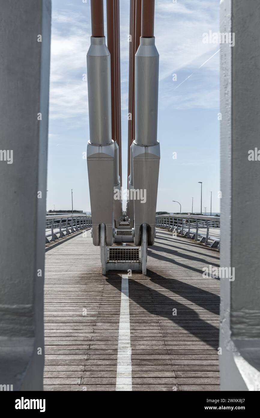 Metal suspenders of a small bridge for road traffic and pedestrians ...