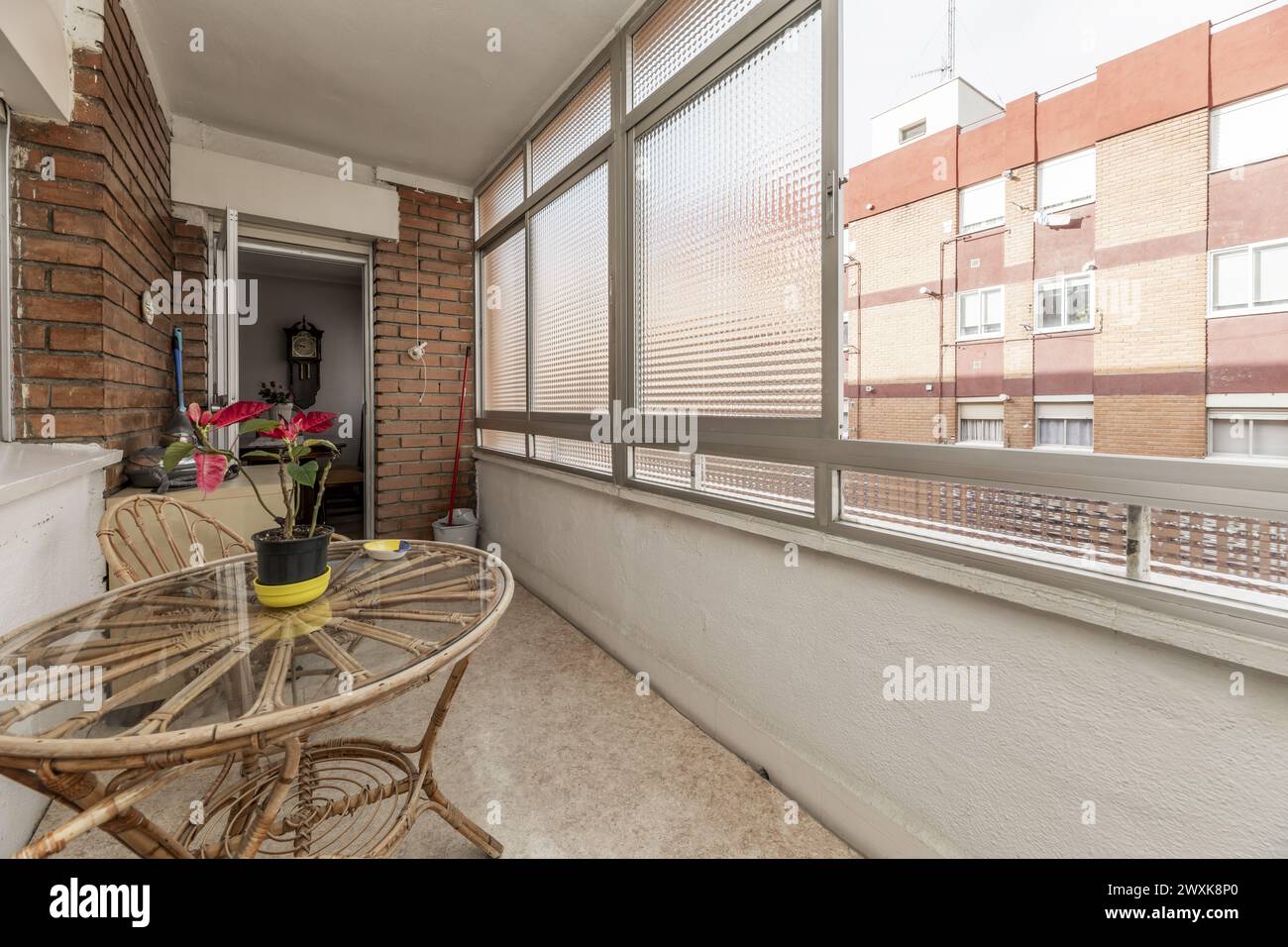 Terrace of a house with light stoneware floors, a round outdoor wicker ...