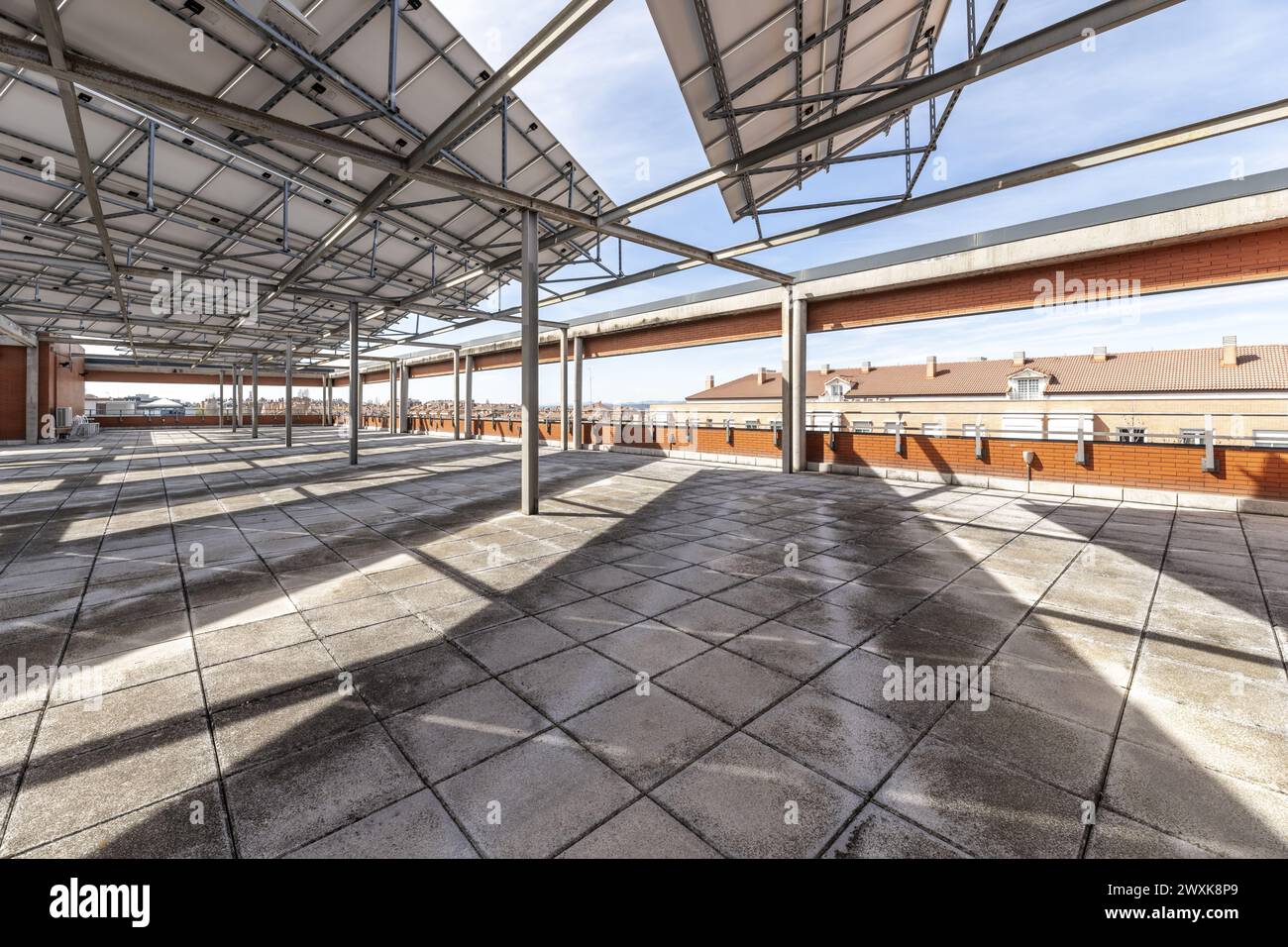 A large empty terrace in the attic of an office building with metal ...
