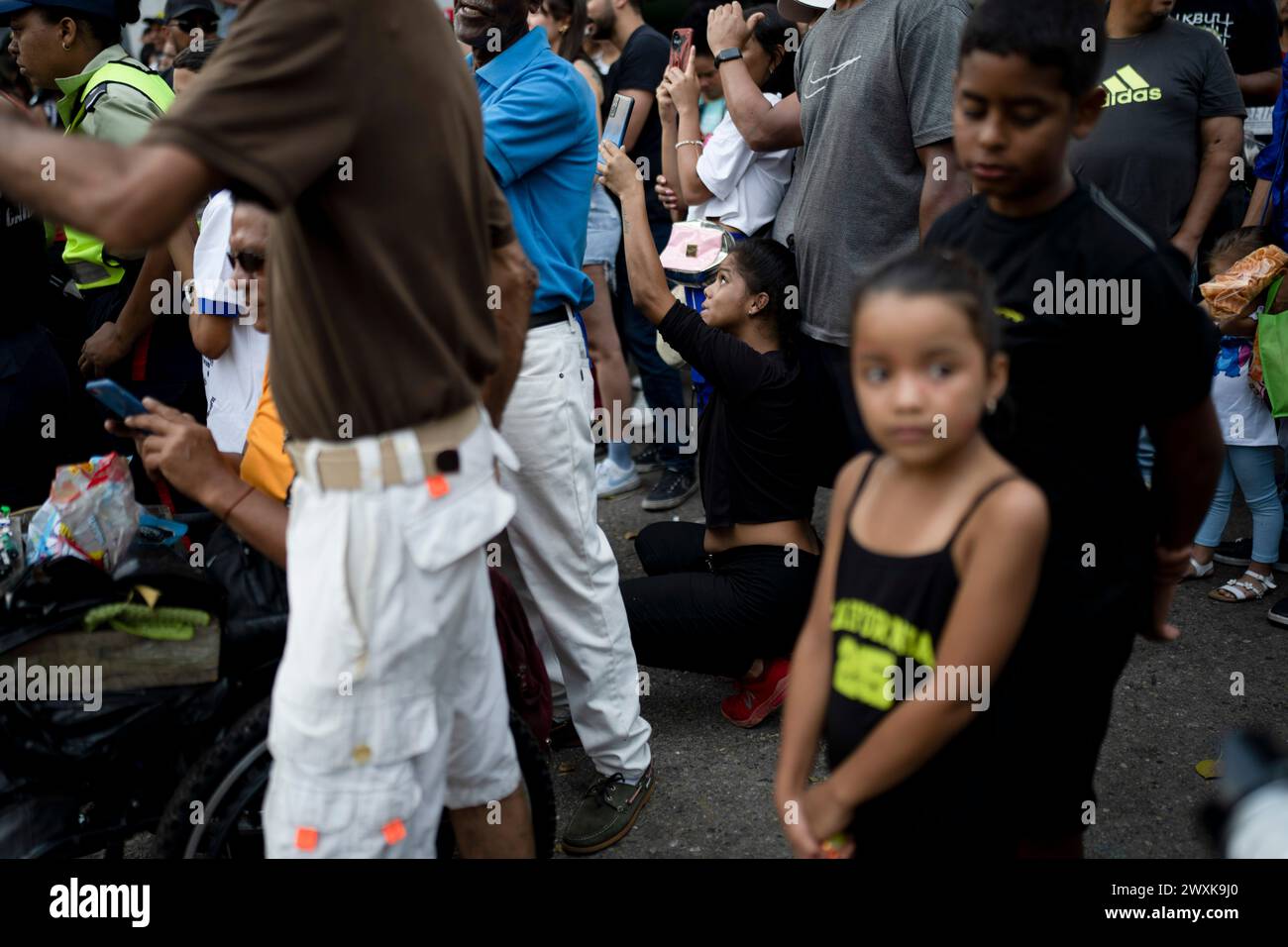 A resident takes pictures during the traditional event of burning Judas ...