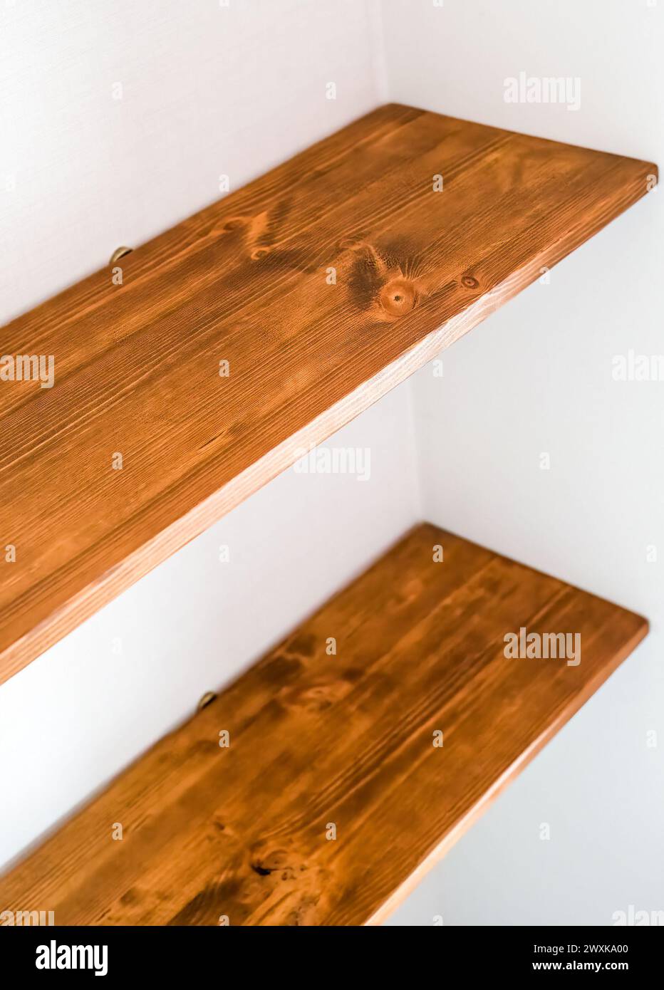 two empty wooden shelves on a white wall Stock Photo - Alamy