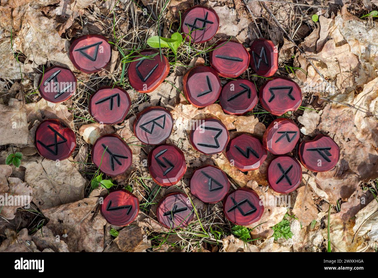 Red runes carved from wood on the ground Stock Photo - Alamy