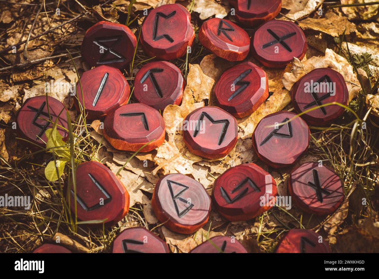 Red runes carved from wood on the ground Stock Photo - Alamy