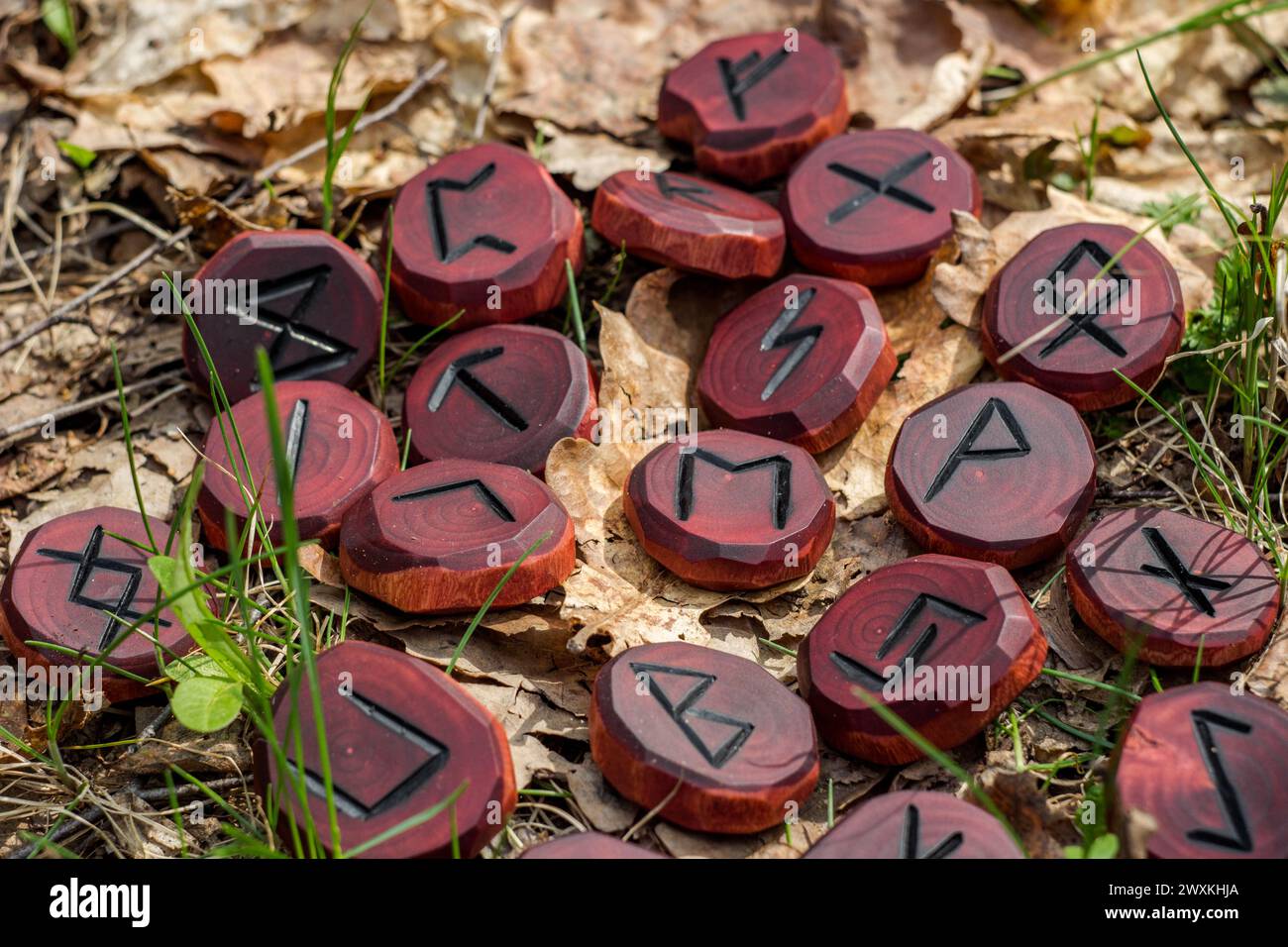 Red runes carved from wood on the ground Stock Photo - Alamy