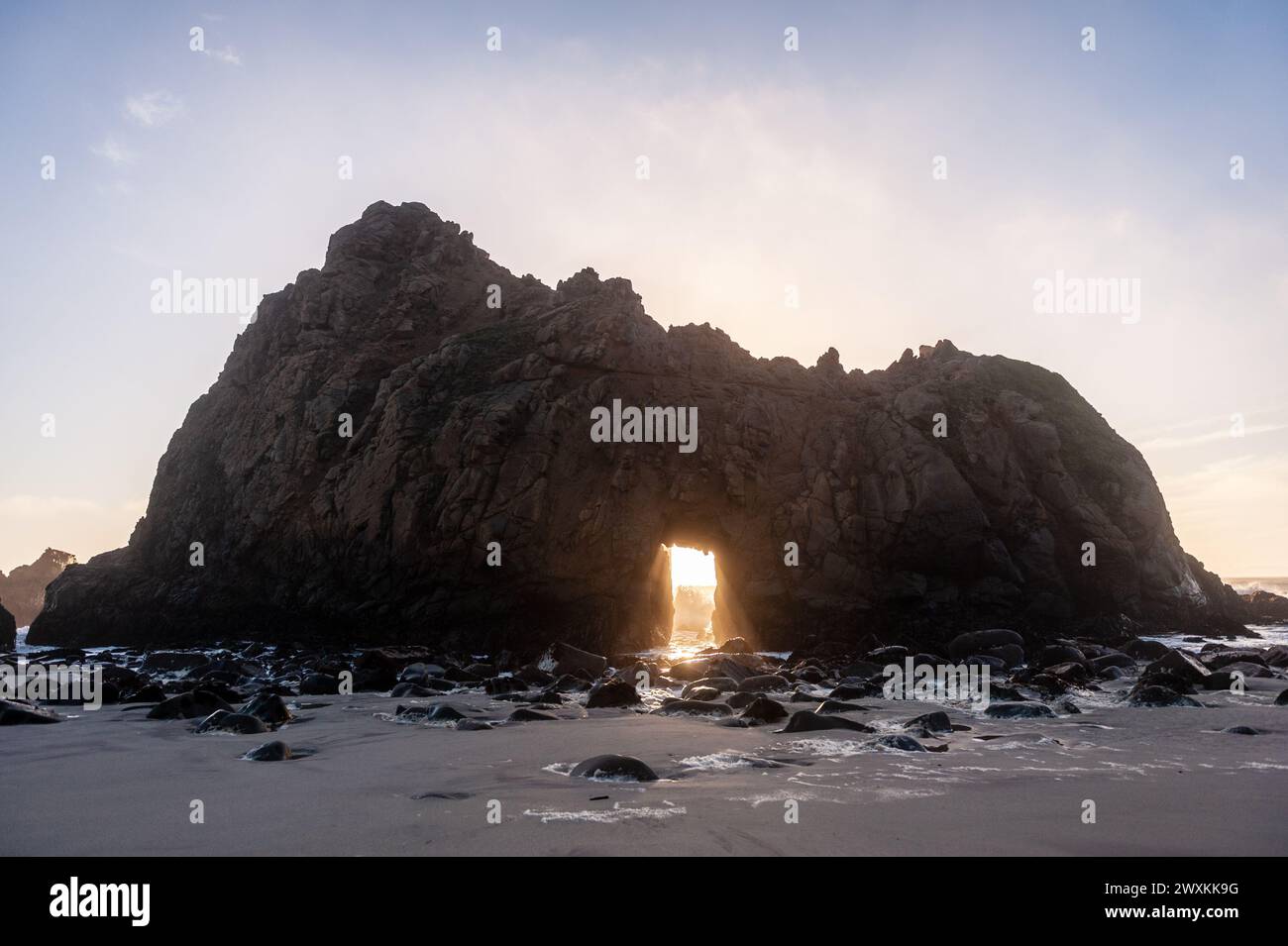 Wide-angle shot of the keyhole arch at Pfeiffer beach, California, whit ...