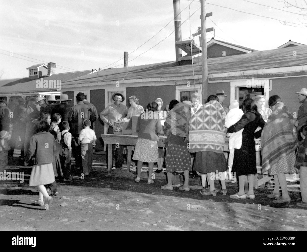 People standing in a line on a cold day, possibly on the Wind River ...