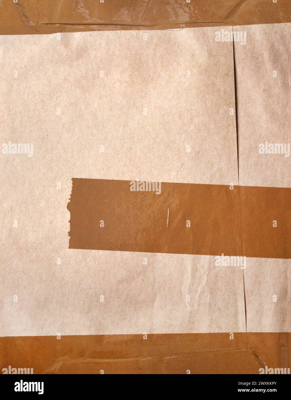 Paper package covered in adhesive tape. Masking tape with paper ...