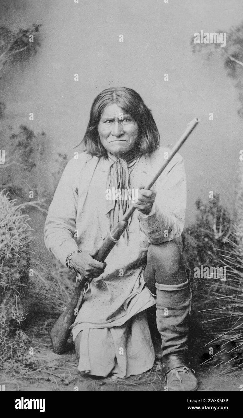 Geronimo (Goyathlay), a Chiricahua Apache; full-length, kneeling with ...