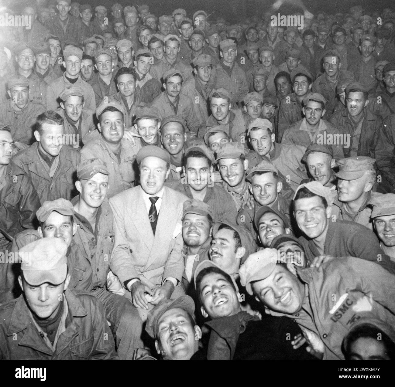 Bob Hope, radio and screen star, sits with men of X Corps, as members ...