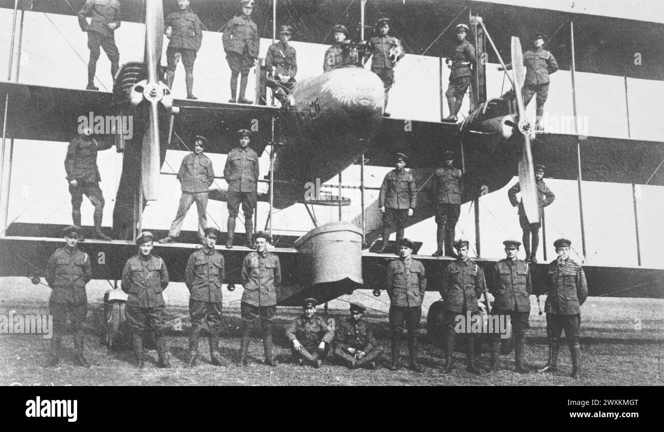 Aviators or soldiers standing on the wings of a Caproni three winged ...