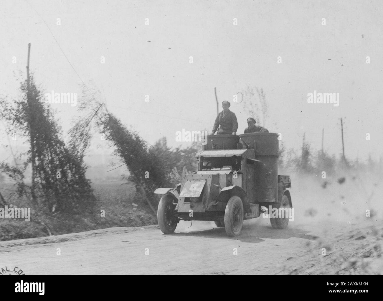 Soldiers atop a British army armrored car on its way toward the front ...