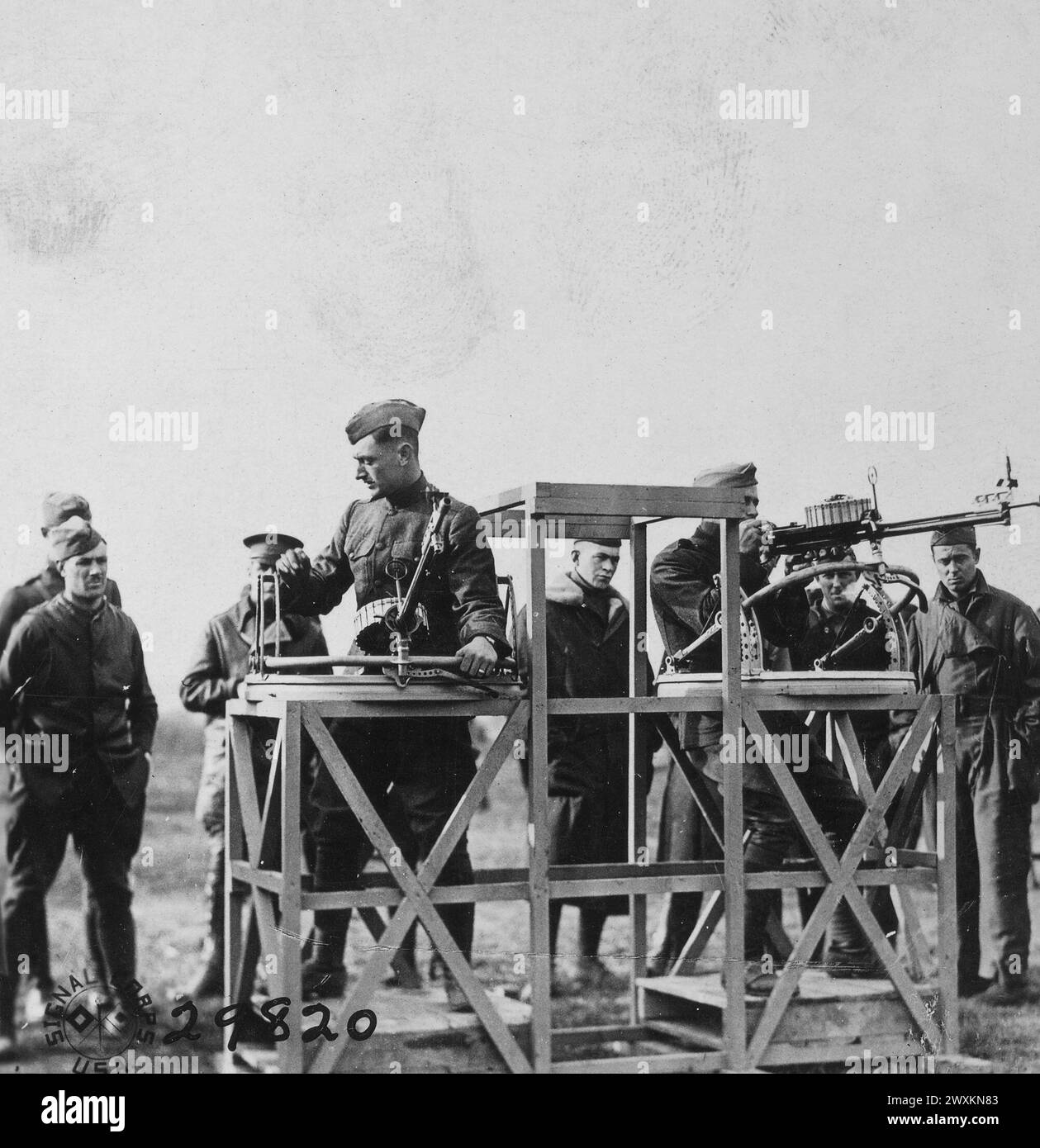 An instructor teaches soldiers how to use a machine gun mounted on a ...