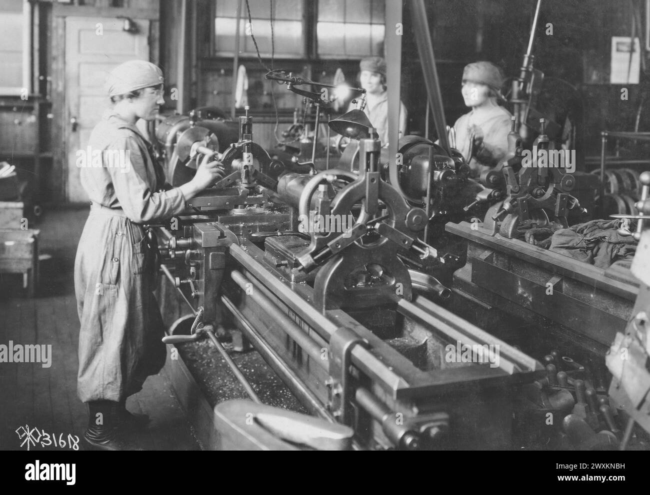 (Original caption) Women workers in munitions plants: Woman operating a ...