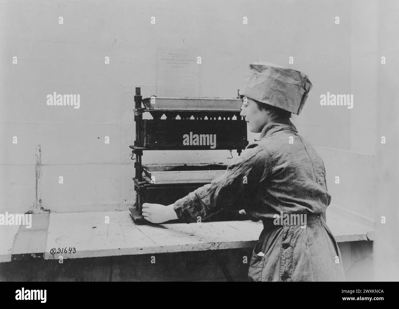 (Original caption) Women workers in munitions plants: Woman using a ...