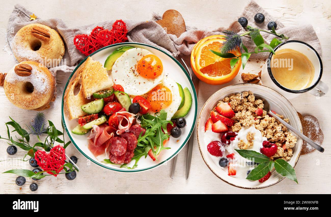 Healthy breakfast with oatmeal, berries, egg, bacon and a cup of coffee ...