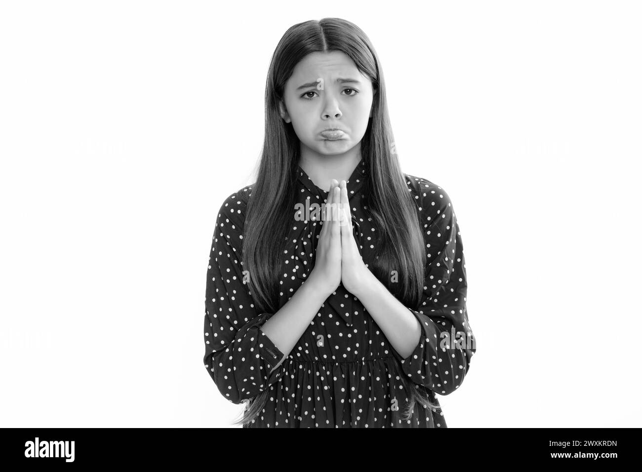 Funny face. Teenager child girl praying with sad expression over white ...