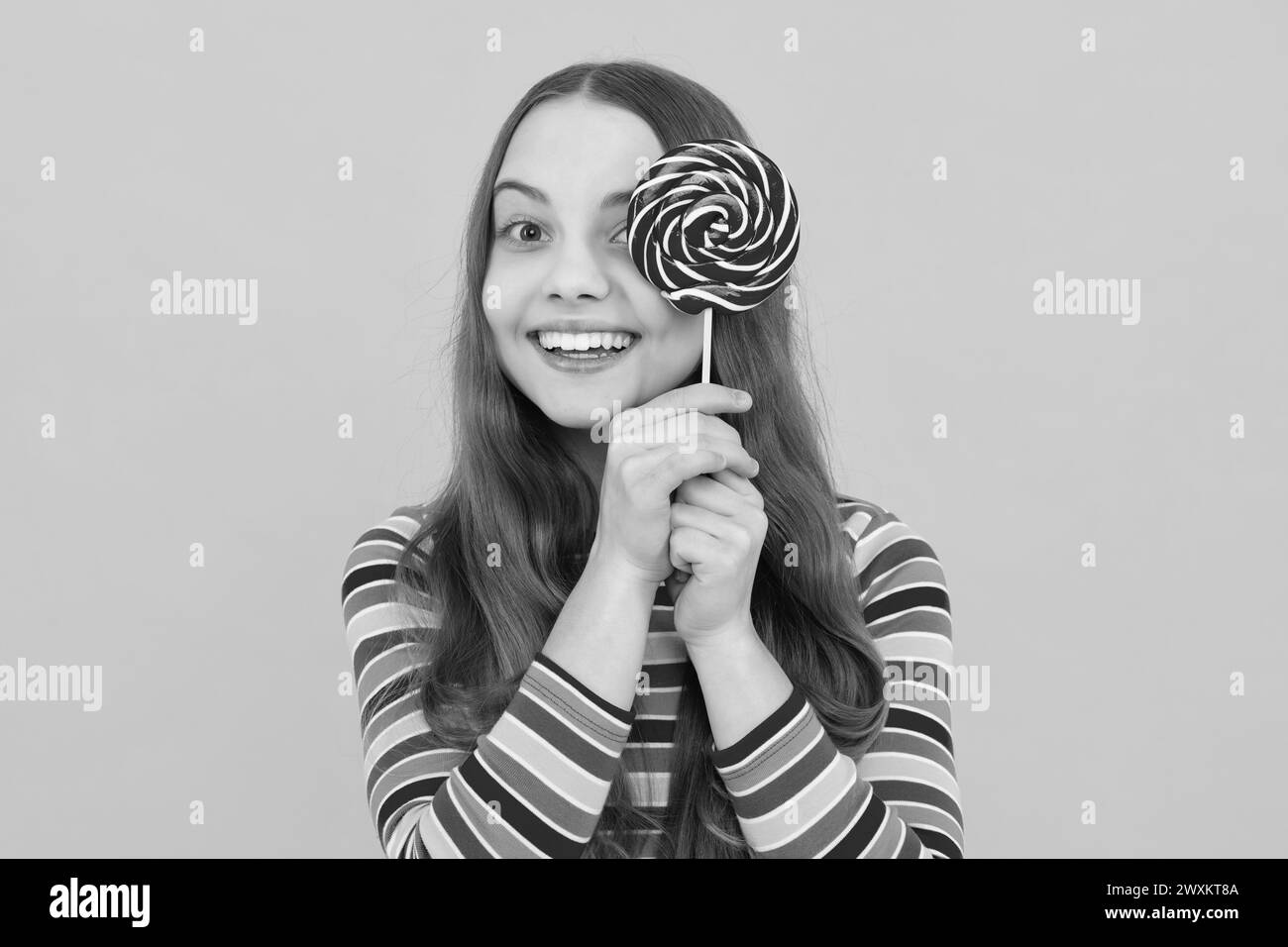 Teenager girl eating sugar lollypop. Candy and sweets for kids. Child ...