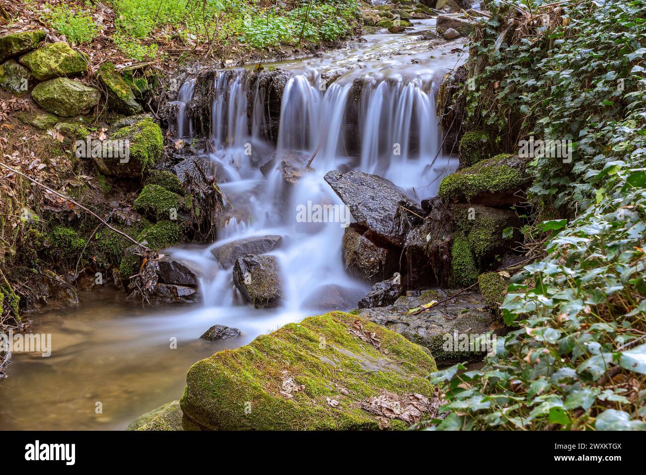 beautiful waterfall long exposure, mountain stream flowing through ...