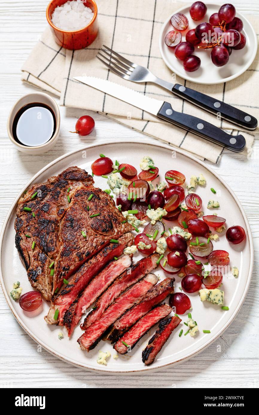 pan fried beef steak served with salad of red grape, crumbled blue mold ...