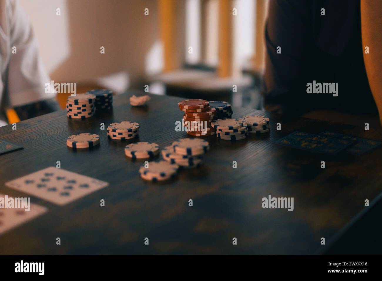 Wooden table with dice and two men playing games Stock Photo - Alamy