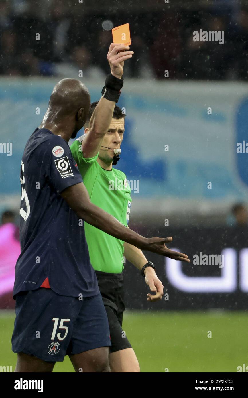 Referee Benoit Bastien gives a red card to Lucas Beraldo of PSG during ...
