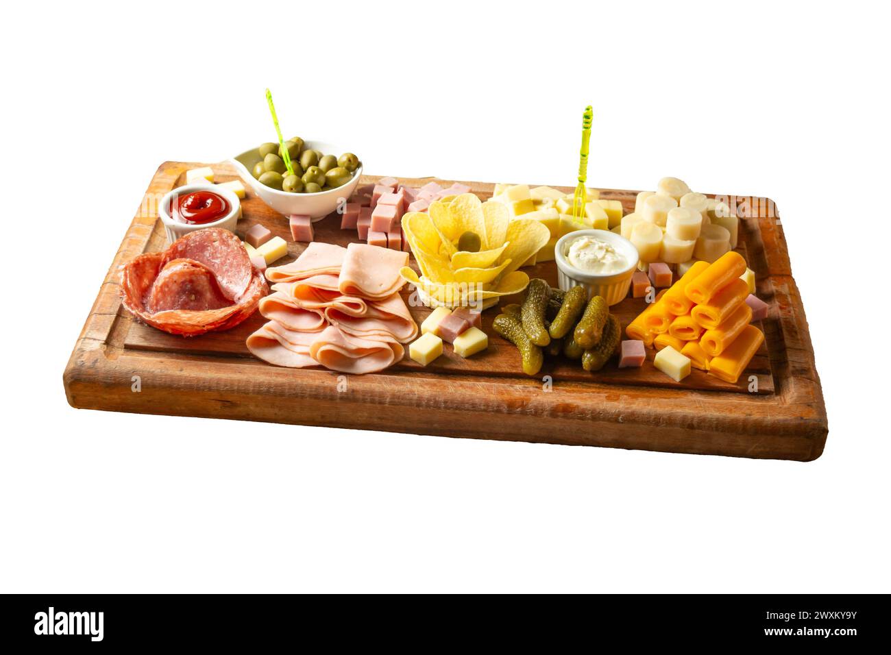 Assorted meats and cheeses on a rustic board Stock Photo - Alamy