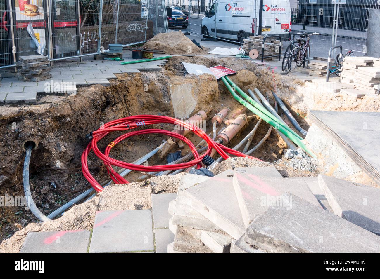 Cable digging roadworks in progress Stock Photo - Alamy
