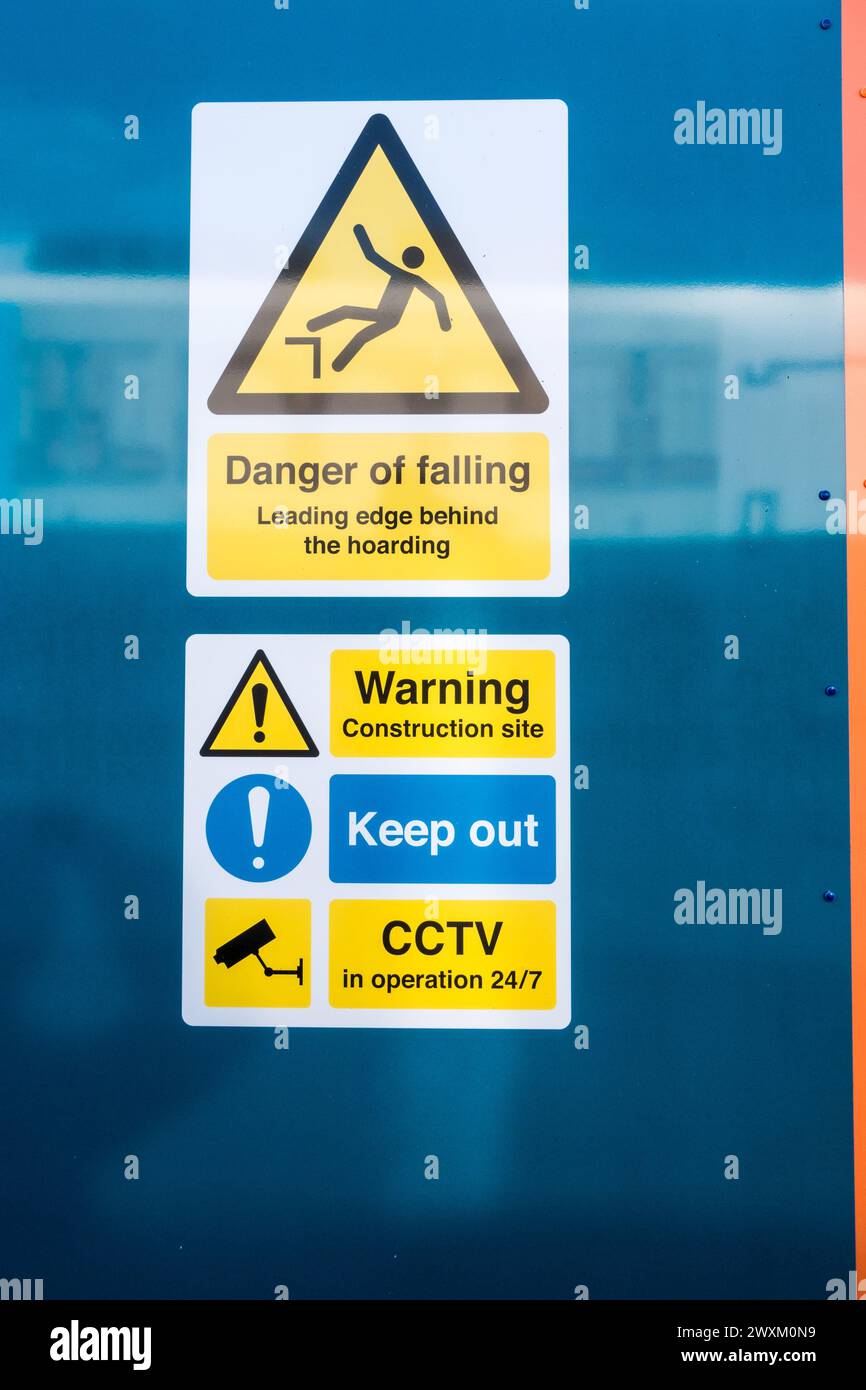 Construction site warning about leading edge and CCTV Stock Photo - Alamy