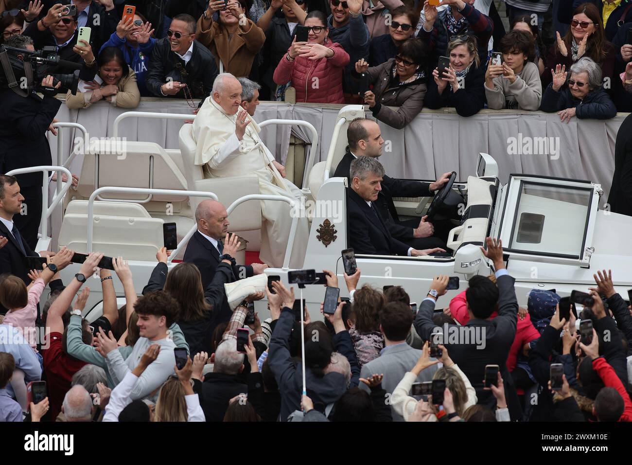Vatican City, Italy 31.03.2024: The pope on the pope mobile goes around ...