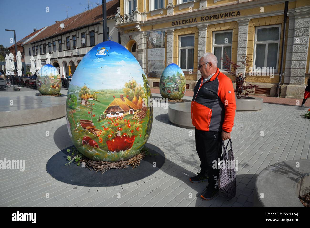 Koprivnica. 30th Mar, 2024. A man views a giant Easter egg during the ...