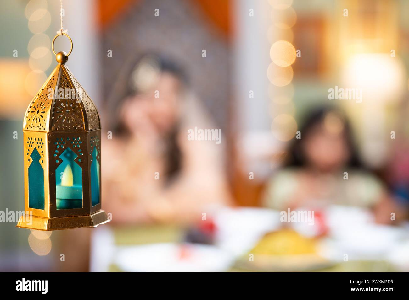 Close up shot of indain muslim family to hanging lantern while eating ...