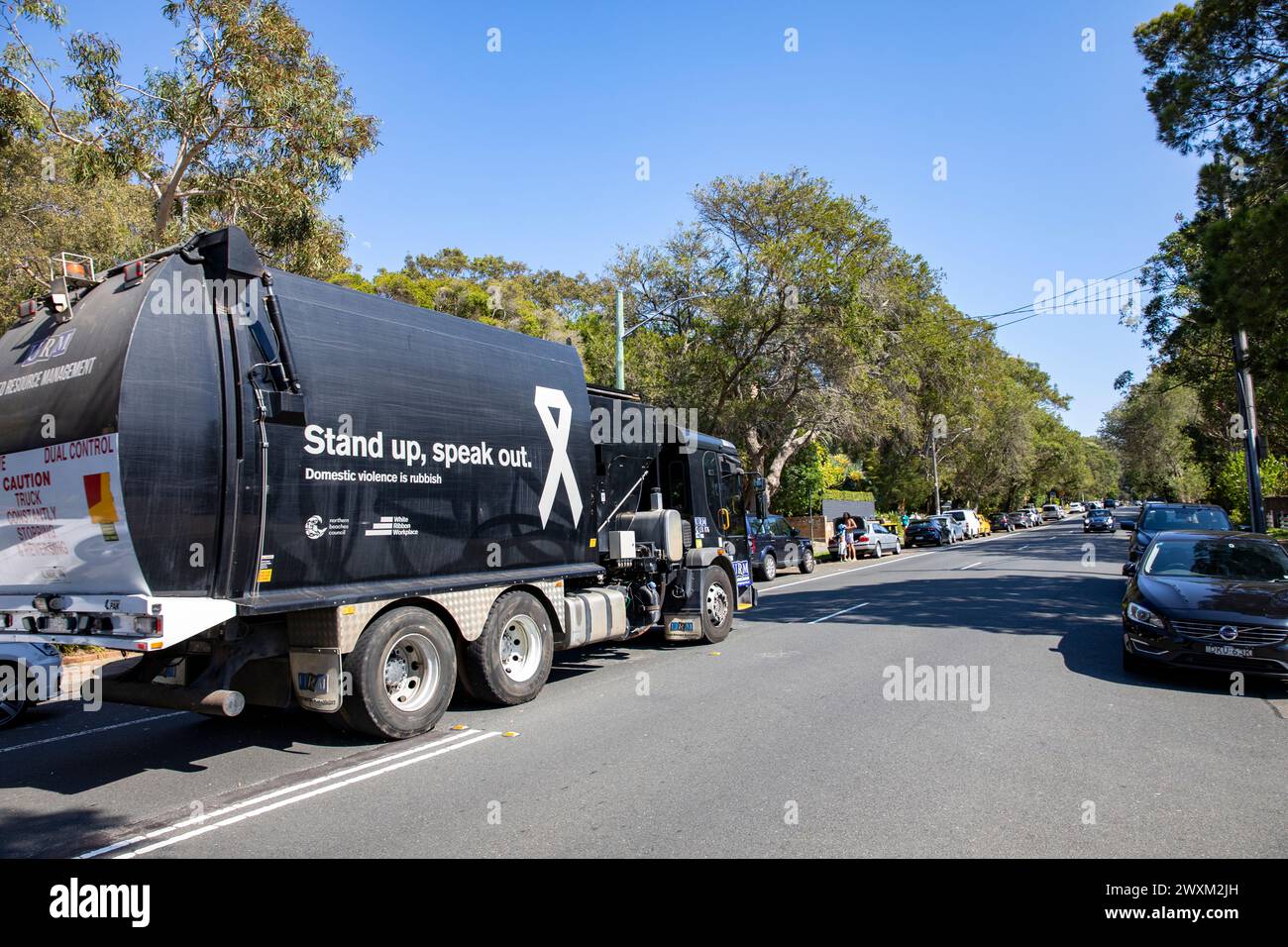 Australia, rubbish garbage collection truck displays message Stand Up ...