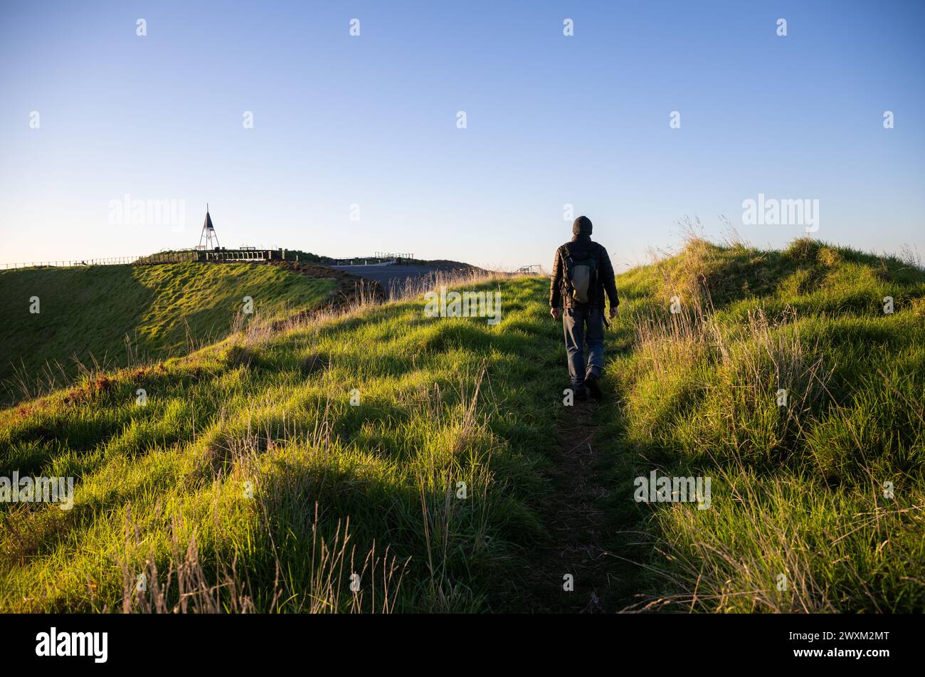 Man walking on the crater rim at Mt Eden summit. Auckland Stock Photo ...