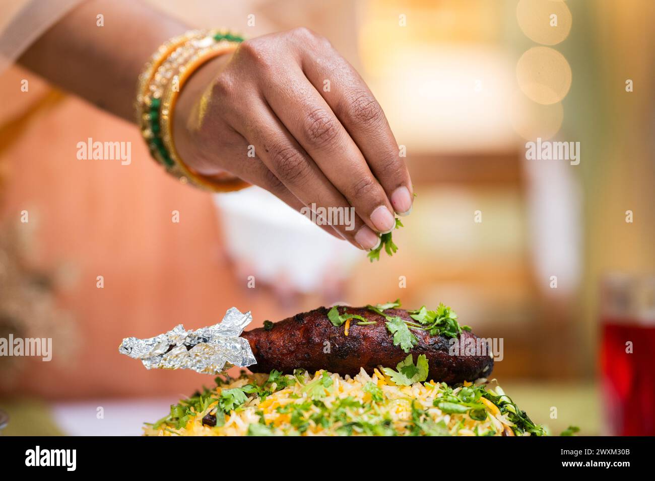 Extreme close up shot of indian woman hands adding toppings or ...