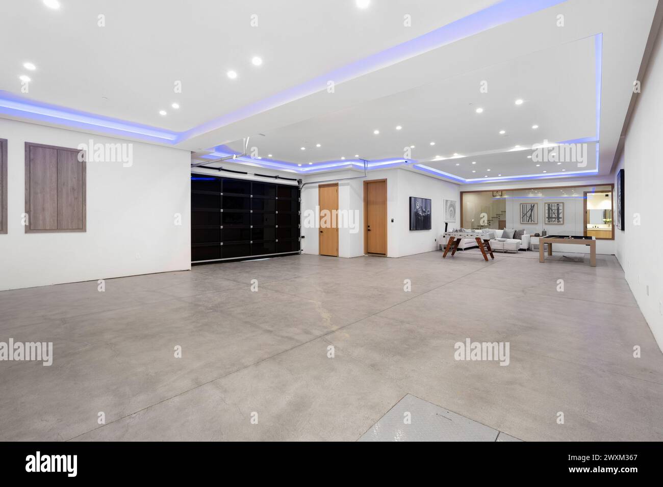 A modern room with open garage and white sofa Stock Photo - Alamy