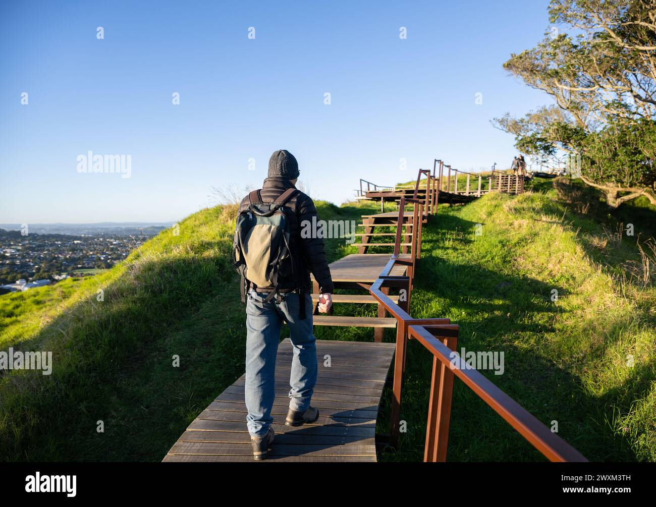 Man walking on the boardwalk around the crater at Mt Eden summit ...