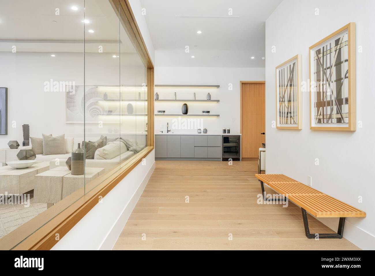 A minimalist lobby with a wooden bench and glass window Stock Photo - Alamy