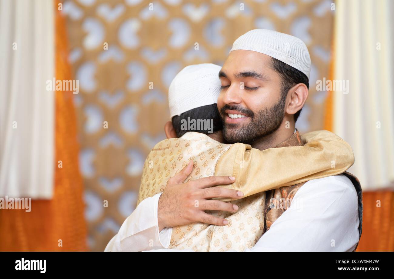 Happy indian Muslim father with kid hugging each other while saying ...