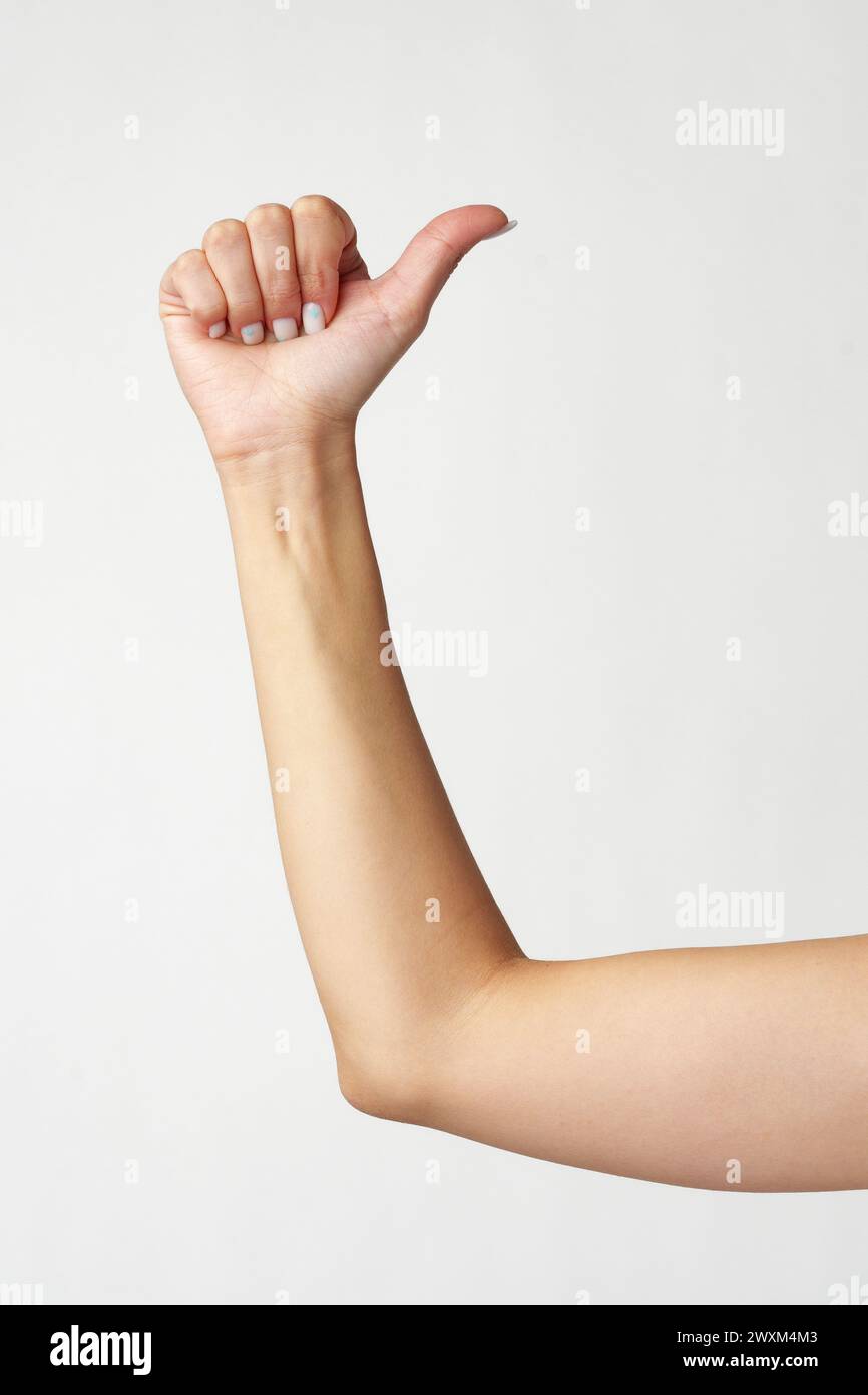Female hand showing thumbs up sign against white background Stock Photo ...